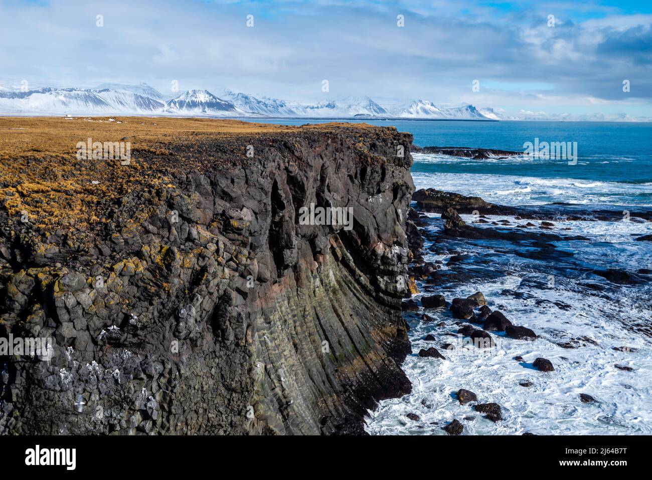 Photograph of the volcanic rock bridge at the Gatklettur Cliff walk ...