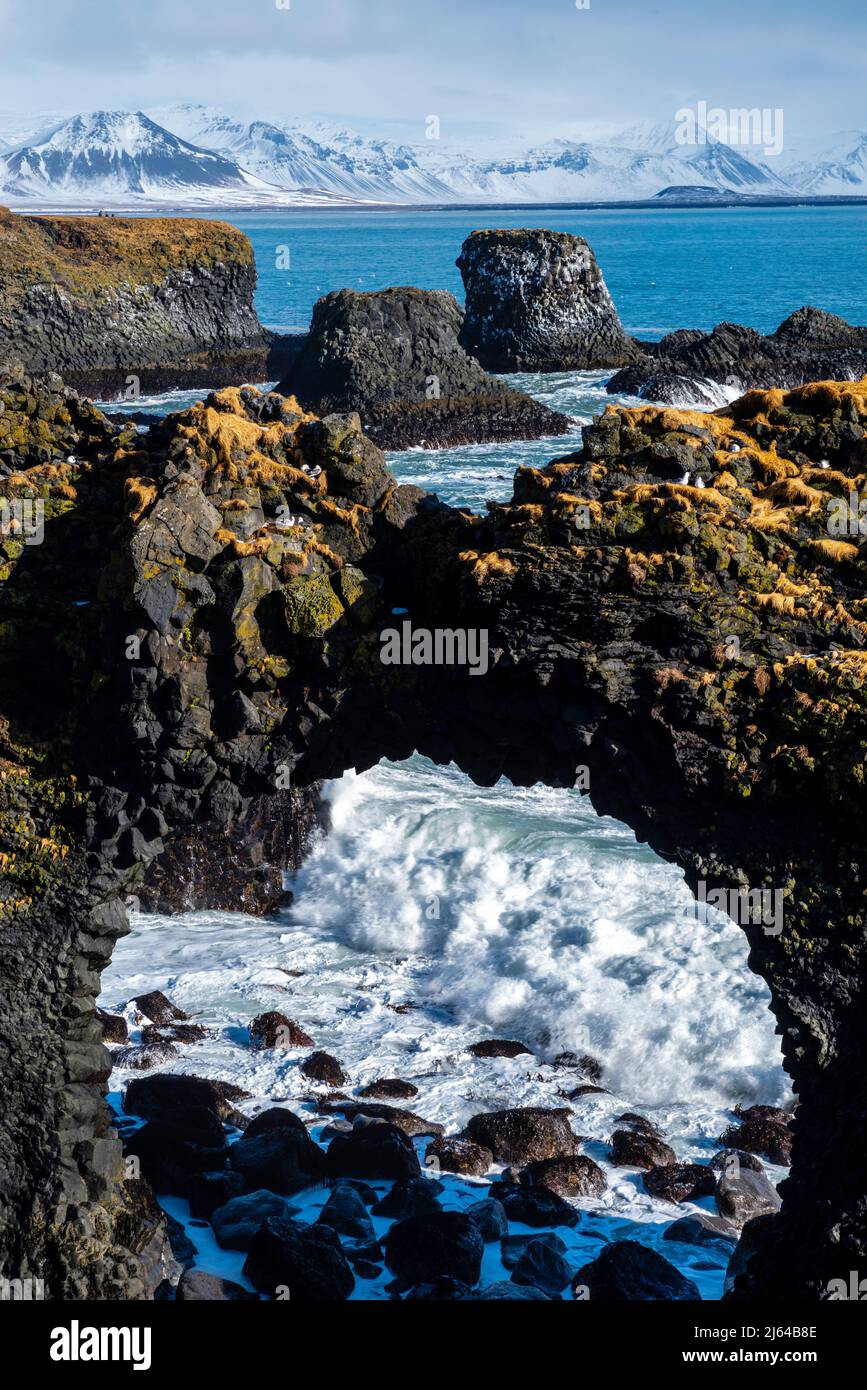 Photograph of the volcanic rock bridge at the Gatklettur Cliff walk ...