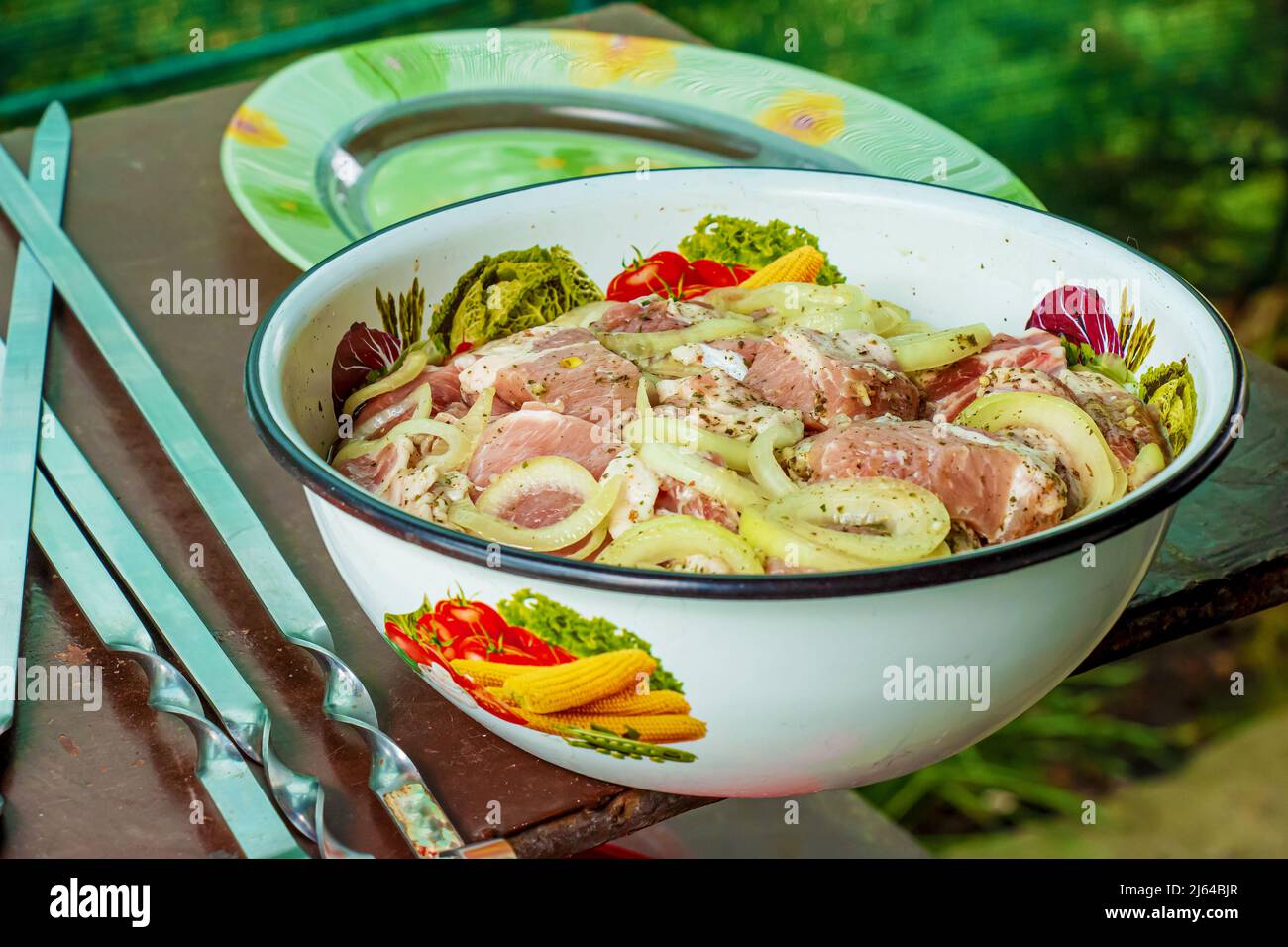 A bowl filled with marinated raw meat for barbecue on fire Stock Photo ...
