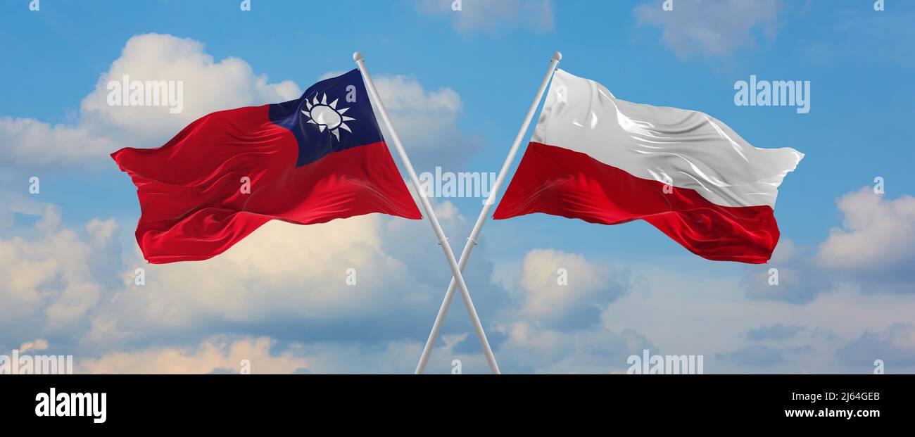 two crossed flags Taiwan and Poland waving in wind at cloudy sky ...