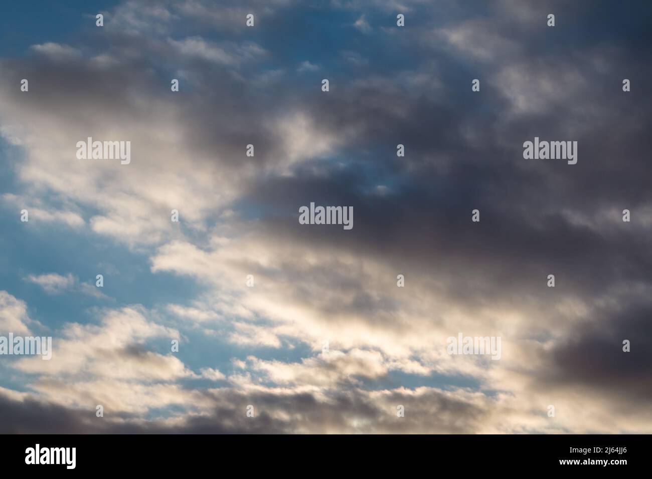 Dark stormy high clouds on blue sky with sunset shine, cloudscape ...