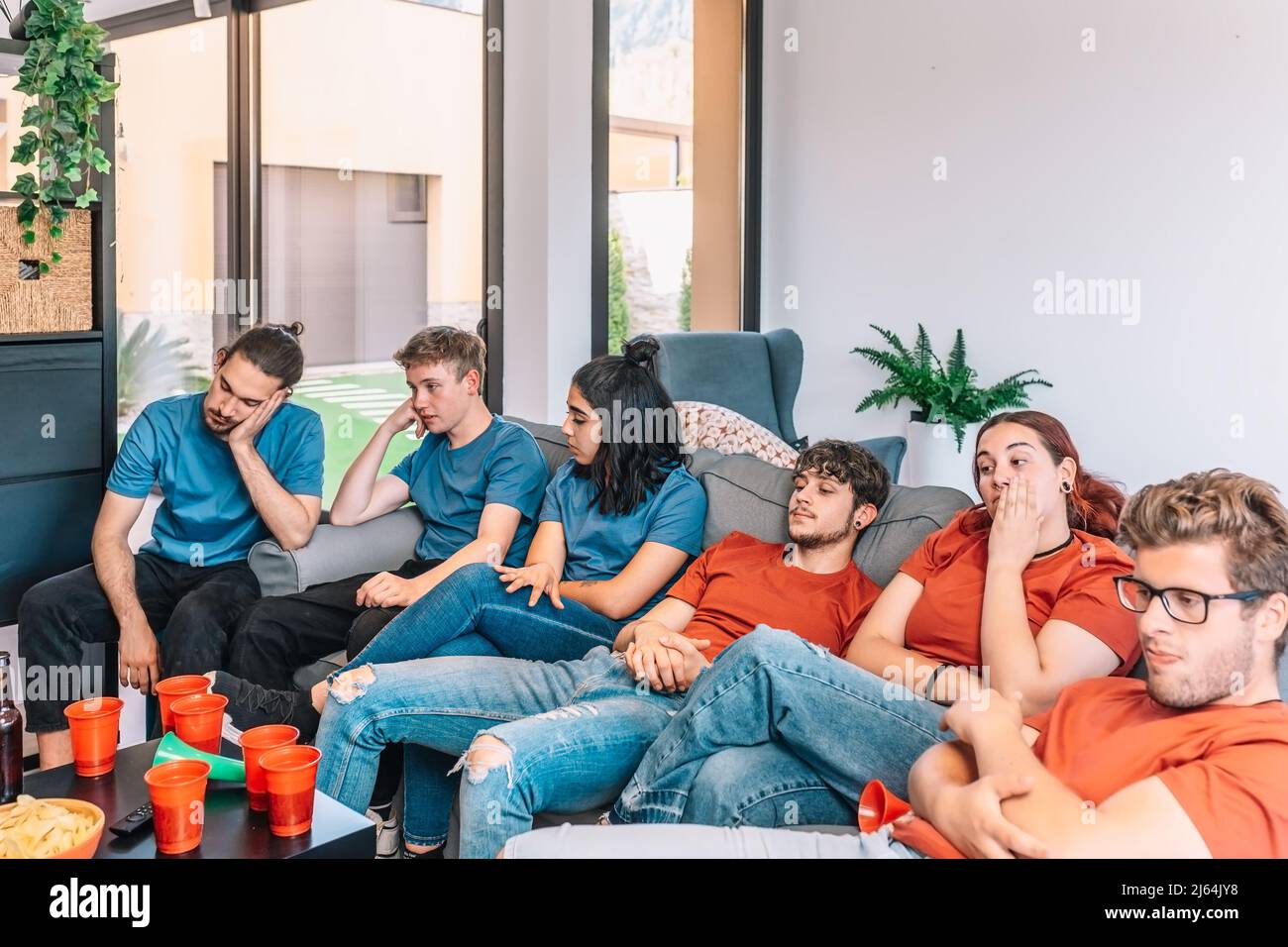 Football fans saddened by their team's defeat. Friends watching ...