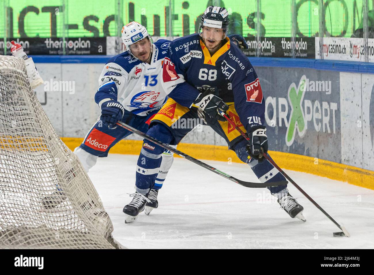 #13 Justin Sigrist (ZSC) against Fabrice Herzog #68 (EV Zug) during the ...