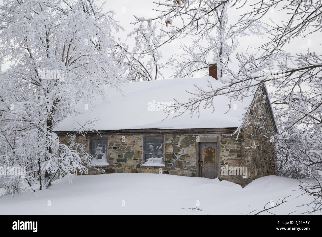 Old fieldstone constructed Tibitts Hill School House through snow ...