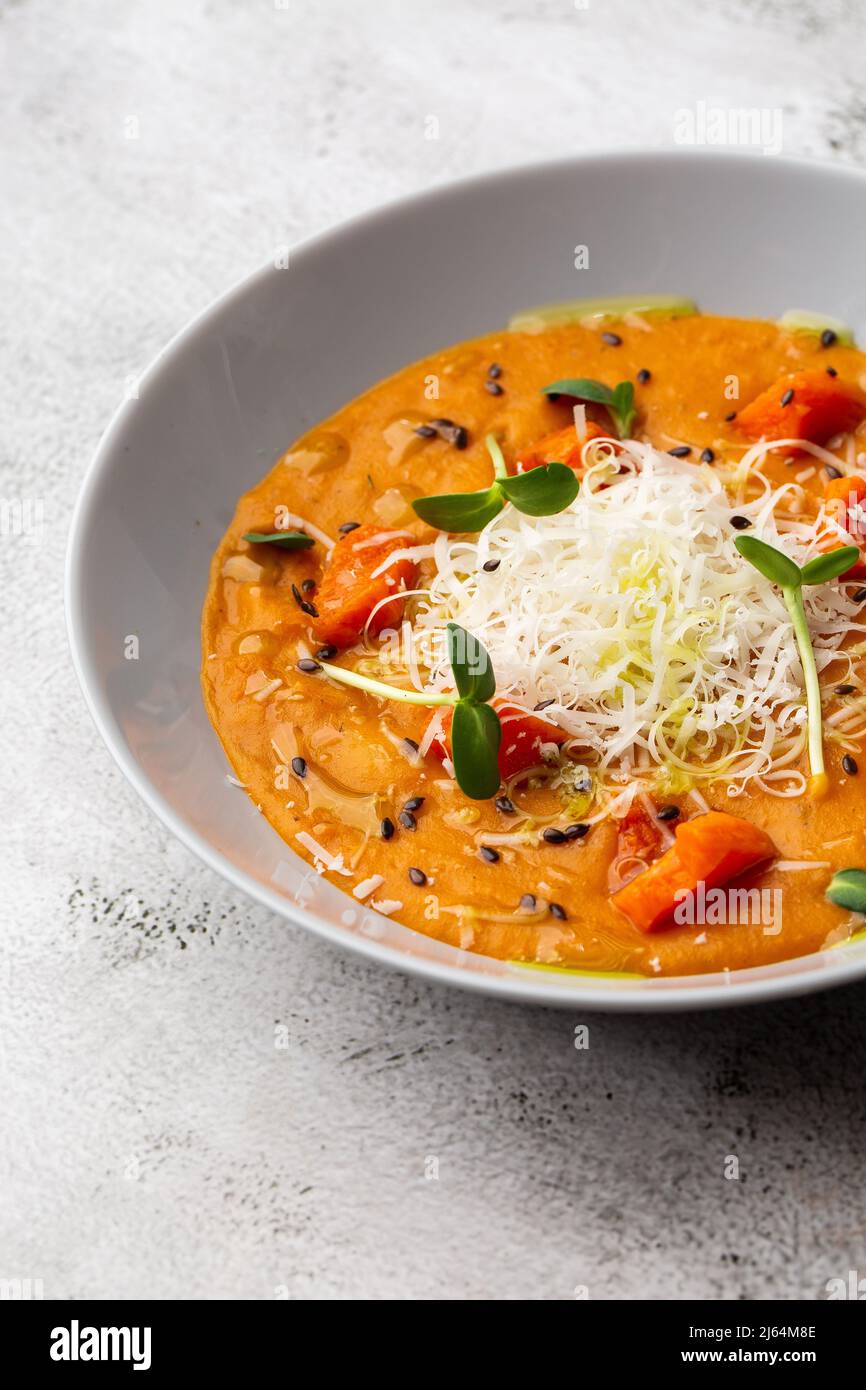 Pumpkin traditional soup with creamy silky texture, garnished with ...