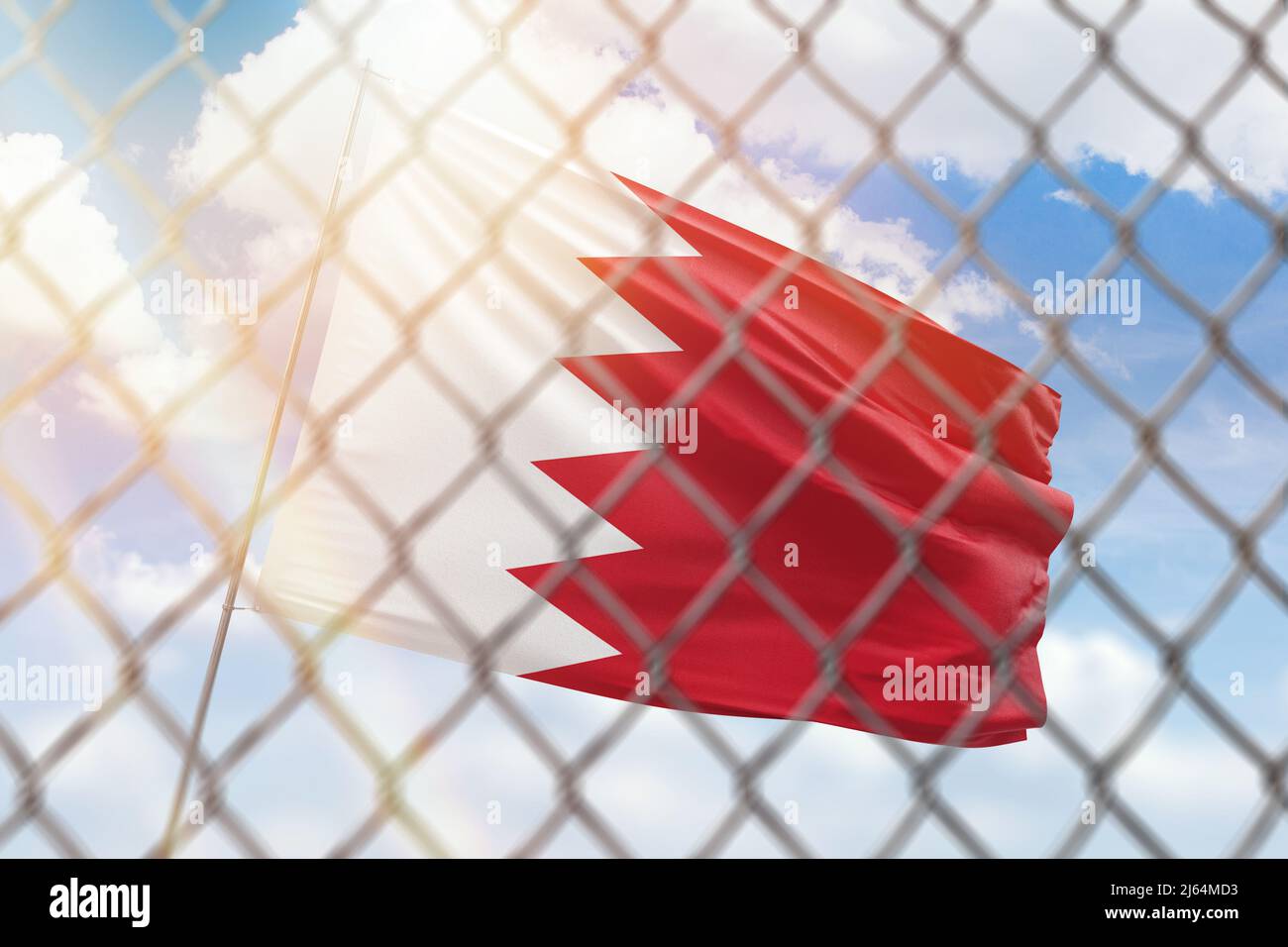 A steel mesh against the background of a blue sky and a flagpole with ...