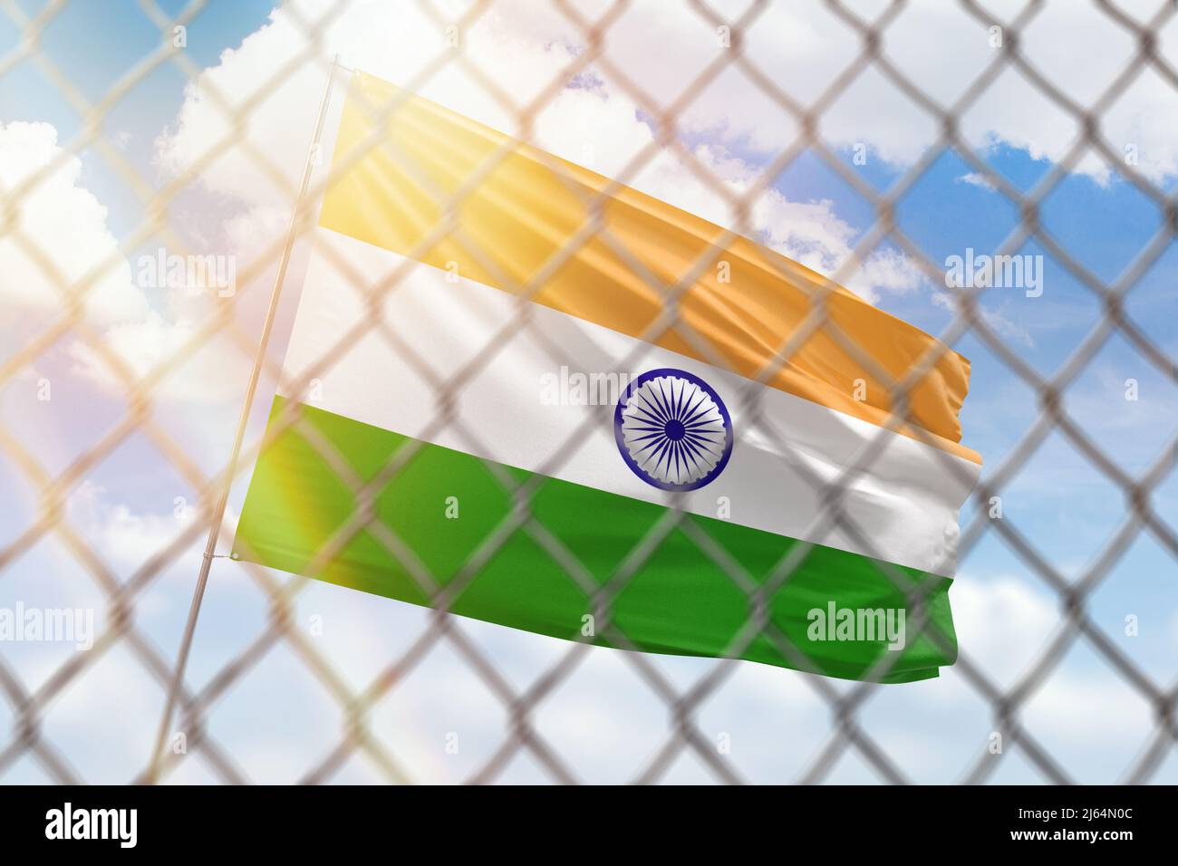 A steel mesh against the background of a blue sky and a flagpole with ...