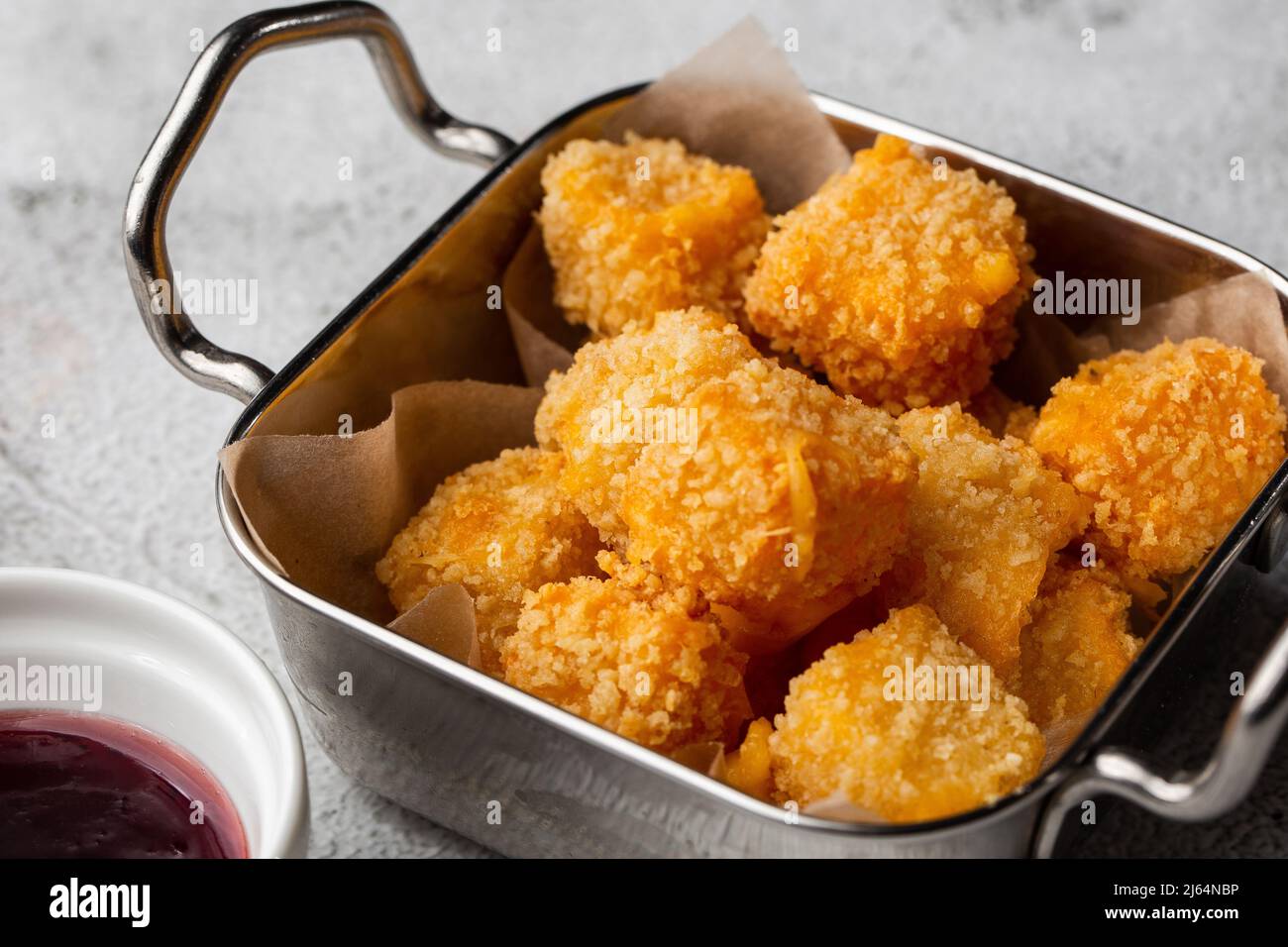 Deep fried Cheese squares served with cranberry sauce in marble ...
