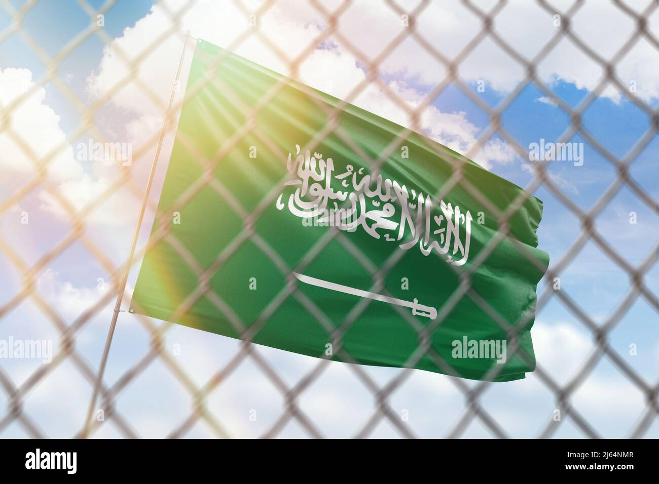 A steel mesh against the background of a blue sky and a flagpole with ...
