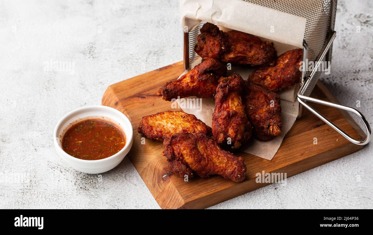 Fried Chicken Wings Covered in True Hot BBQ Sauce served with red hot ...