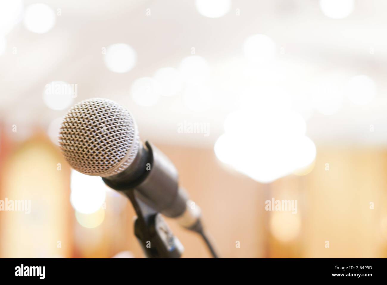 Microphone close up in meeting seminar room blurred background with bokeh, Business background ...