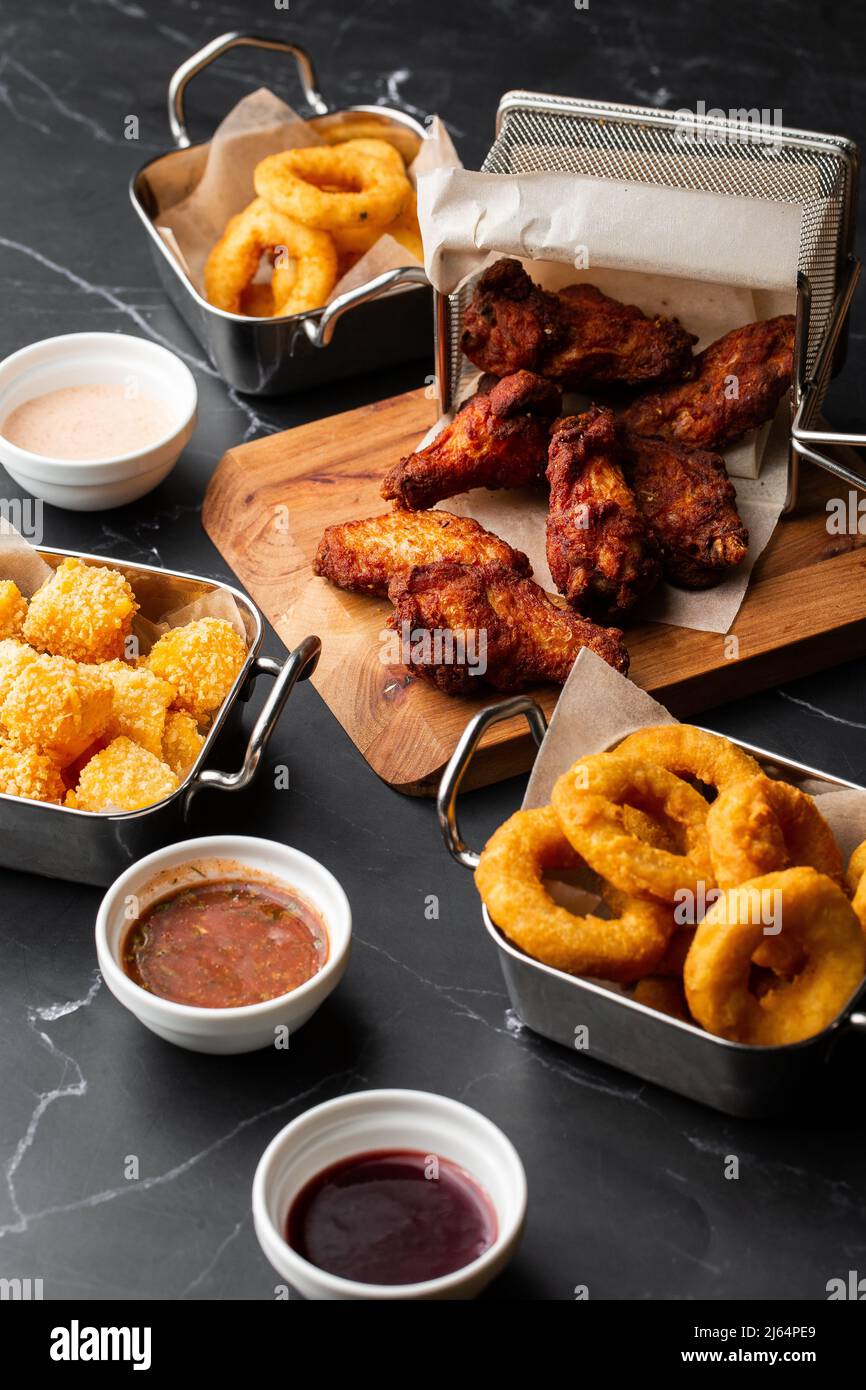 The beer plate with spicy chicken wings, calamari rings, fries onion ...