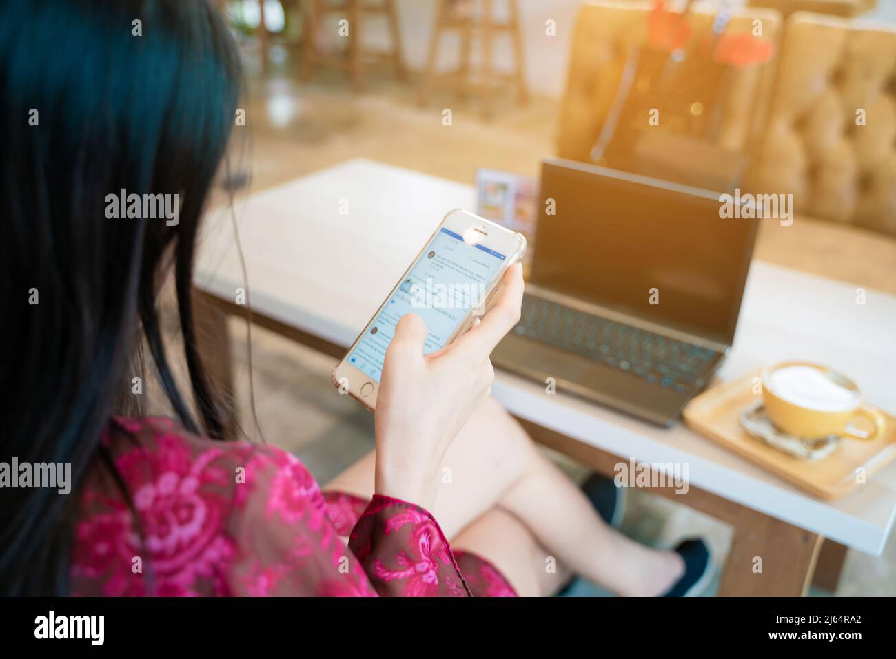 Beautiful asian women texting message on smartphone sitting in coffee ...