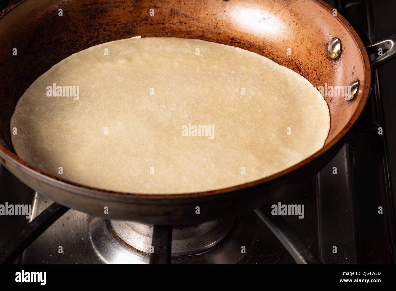 Cooking Tandoori Roti in frying pan, a typical flatbread and popular in ...