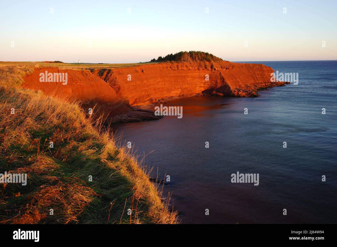 Early morning light bathes the cliffs of Cape Tryon, on Canada's Prince ...