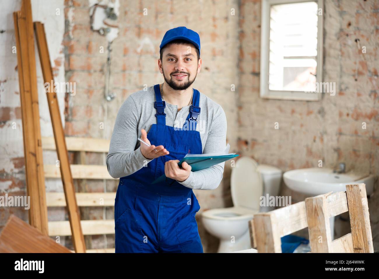 Male foreman checks the completed construction work on drawing Stock ...