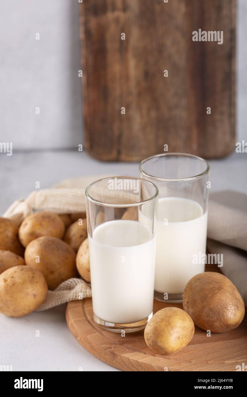 Vegan plant based milk in two transparent glasses. Alternative potato ...