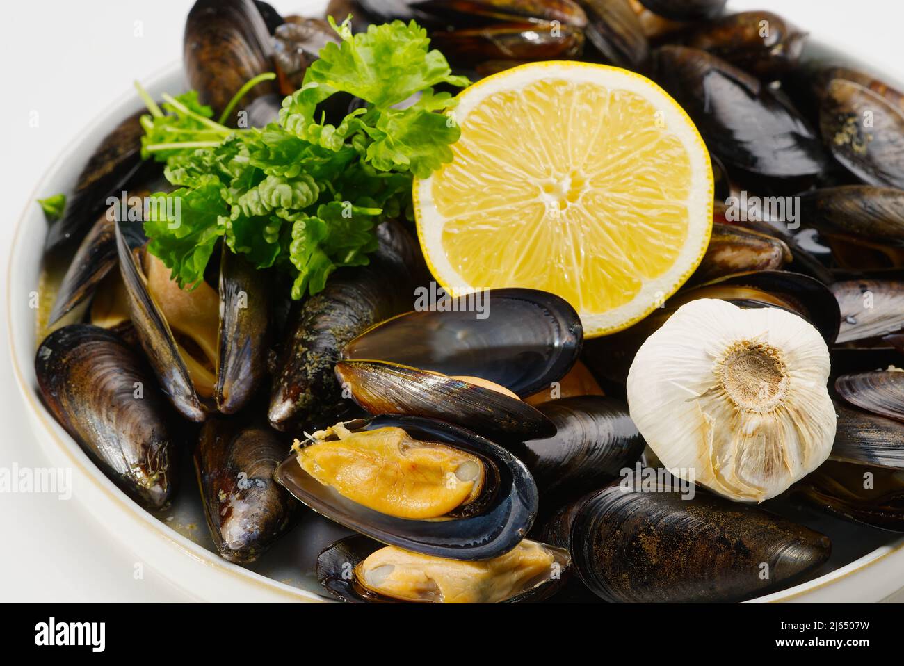 Shellfish dish. Seafood dishes. Mussels in sauce Stock Photo - Alamy