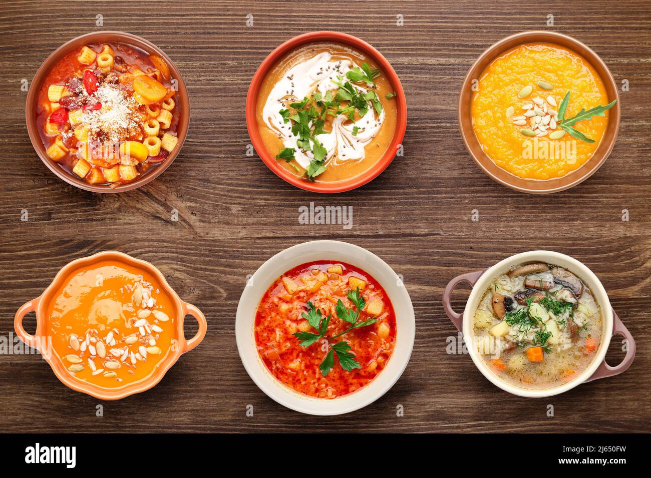 Set of tasty soups on wooden background, top view Stock Photo - Alamy