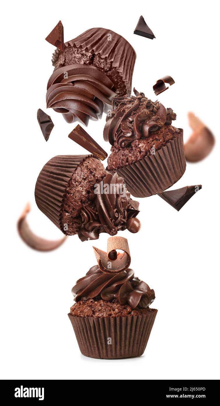 Falling chocolate cupcakes isolated on white Stock Photo - Alamy