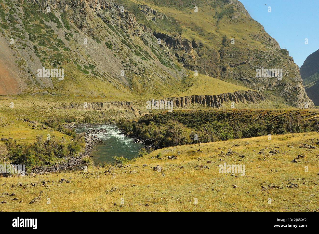 Winding channel of a beautiful turquoise mountain river flowing along ...