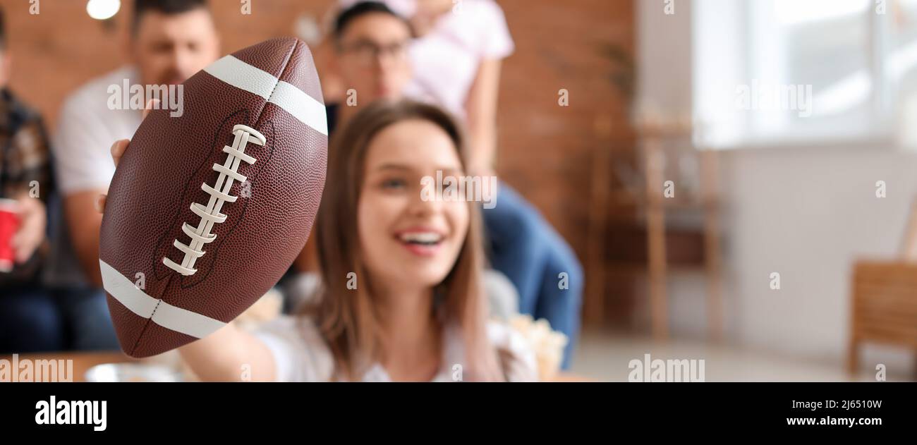 Young woman with friends watching rugby on TV, focus on ball. Banner ...