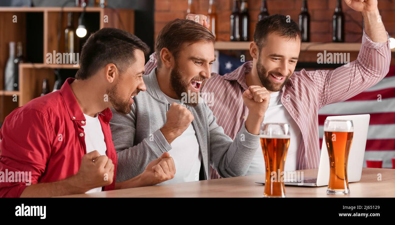 Happy men after winning of their sports bet in pub Stock Photo - Alamy