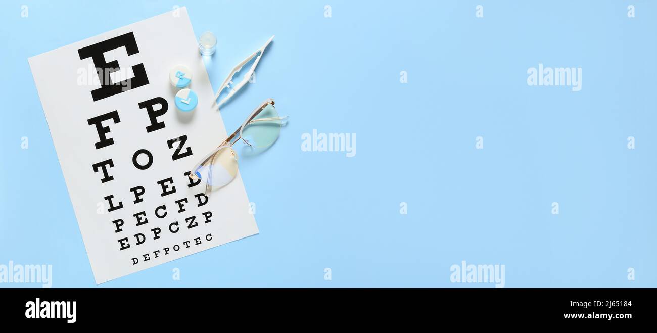 Contact lenses, eye test chart and glasses on light blue background ...