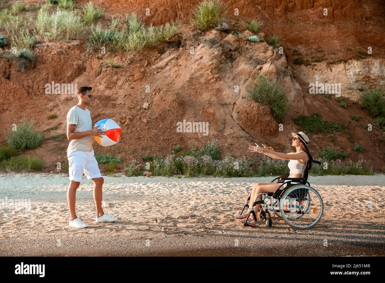 Happy woman with physical disability and her boyfriend playing with ...