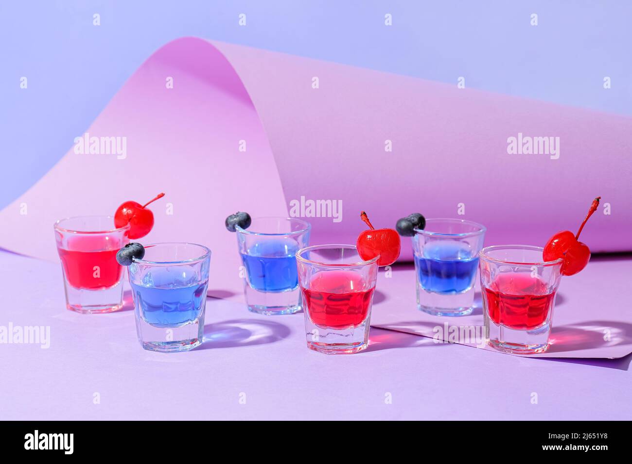 Shot cocktails on color background Stock Photo - Alamy