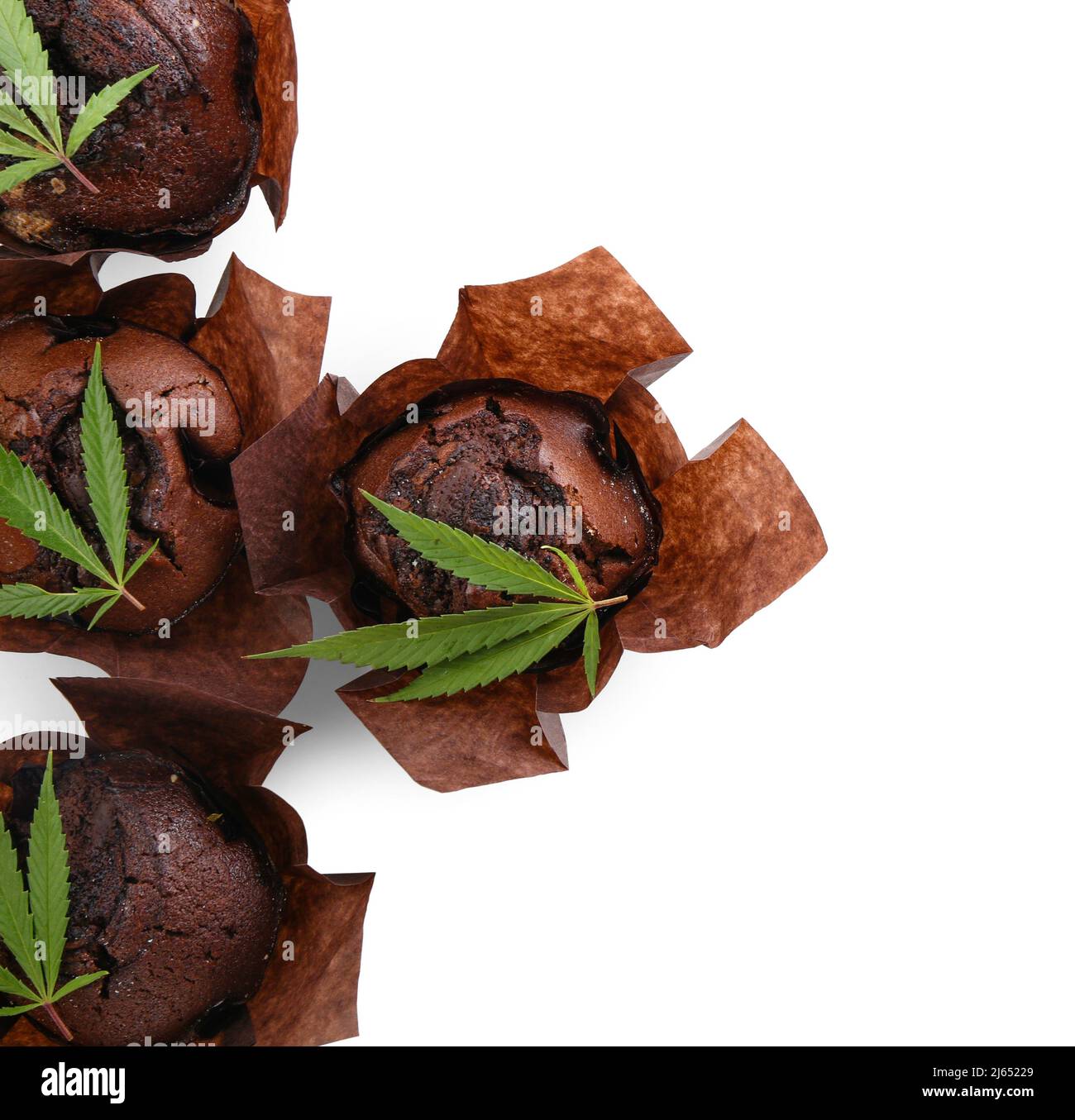 Chocolate cannabis muffins with leaves on white background, closeup ...