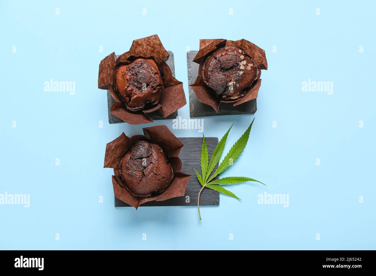 Tasty chocolate cannabis muffins on color background Stock Photo - Alamy