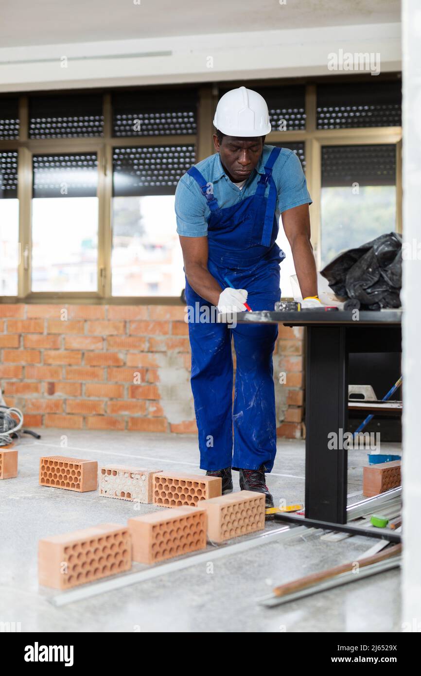 African american foreman making list of building overhaul tasks Stock ...