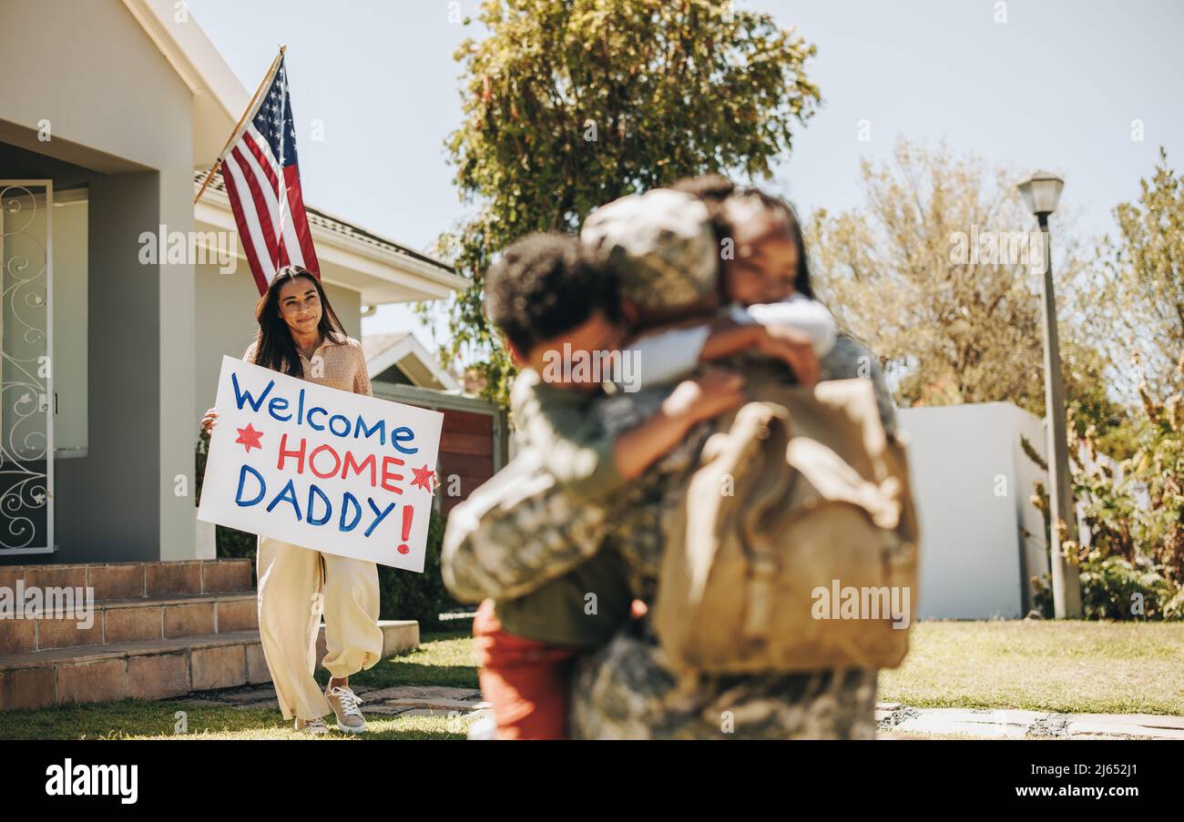 Soldier receiving a warm welcome from his family. Military dad ...