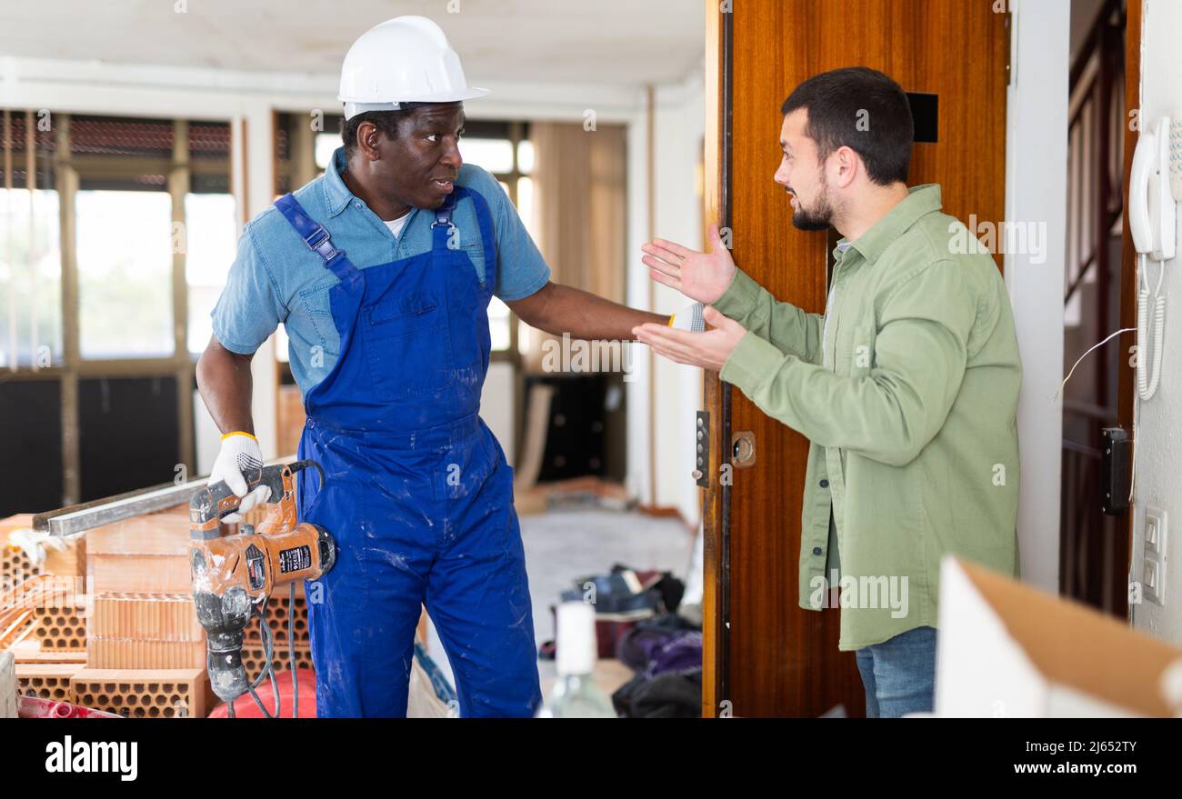 Focused builders posing on indoor construction site Stock Photo - Alamy