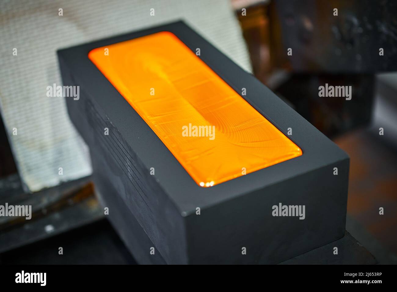 Gold ingot in graphite casting form on workbench at plant Stock Photo ...
