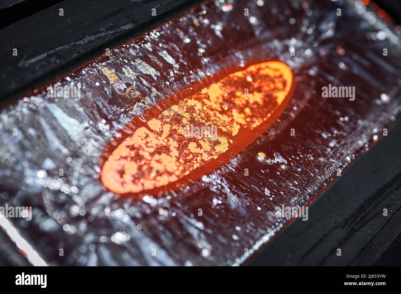 Silver ingot with hot center cools down in casting form Stock Photo - Alamy