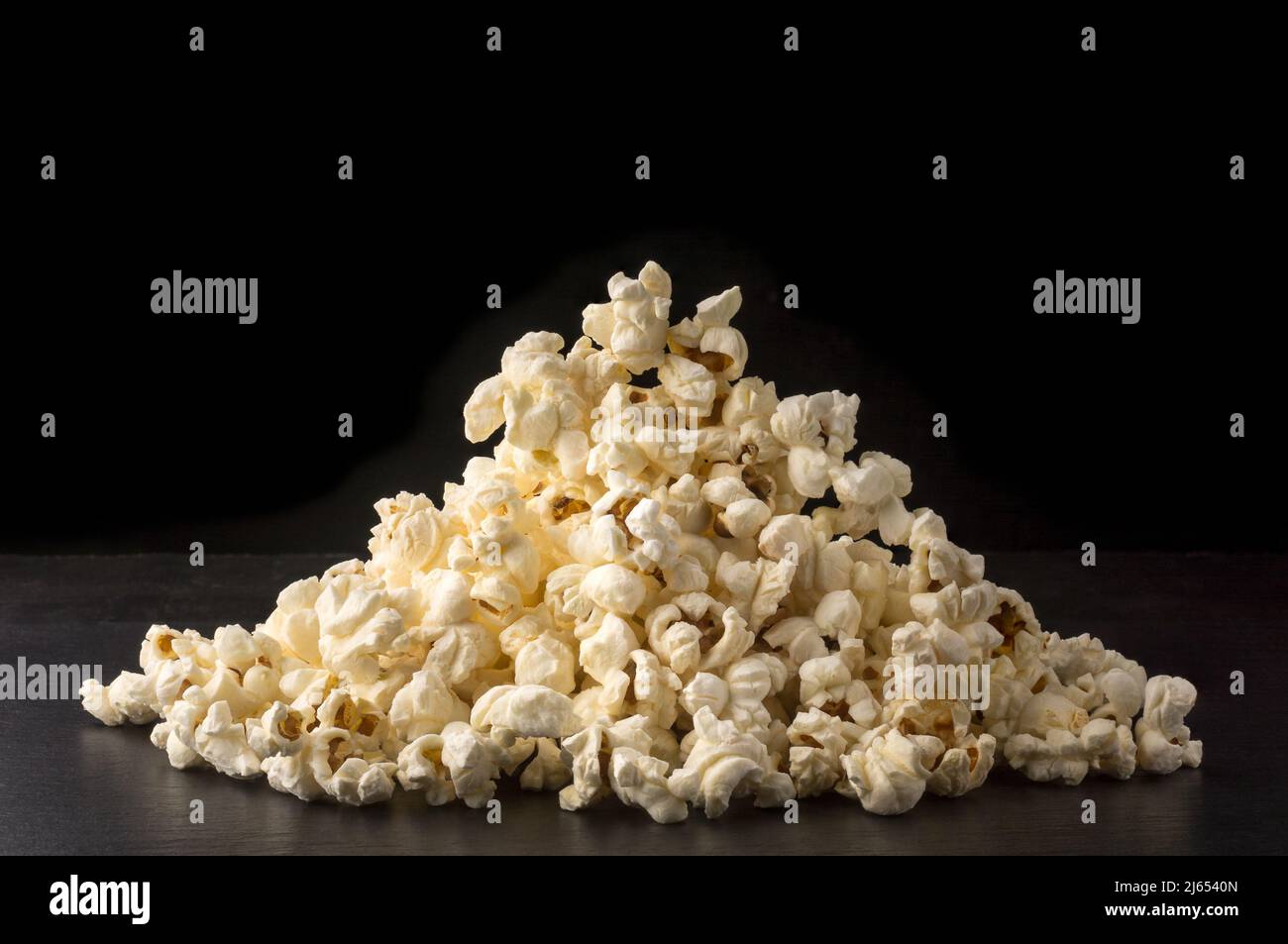 pile of popcorn on black background, delicious, low-fat, healthy snack ...
