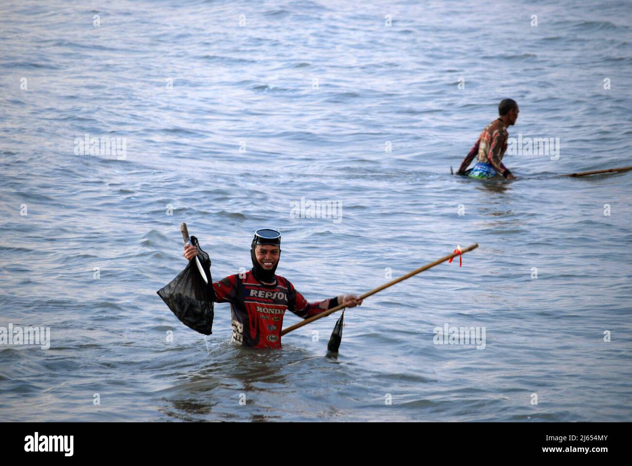 Men with spears fishing shells and scallops on the sea, Valladolid ...