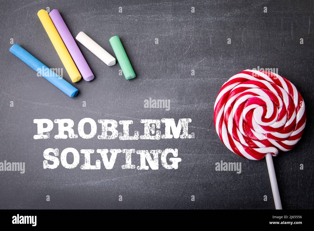 Problem Solving. Colored pieces of chalk on a dark blackboard texture ...