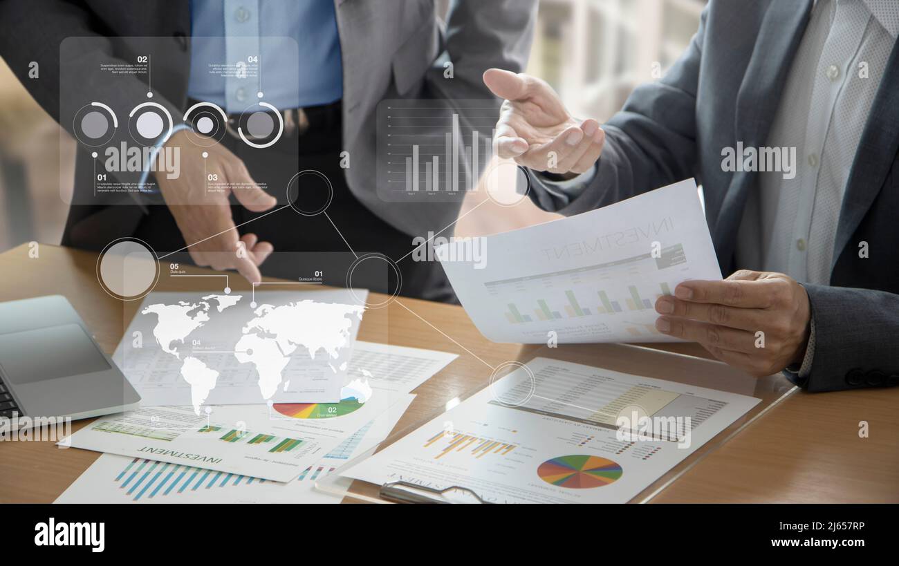 Two businessmen with laptop computer reviewing financial statements for ...