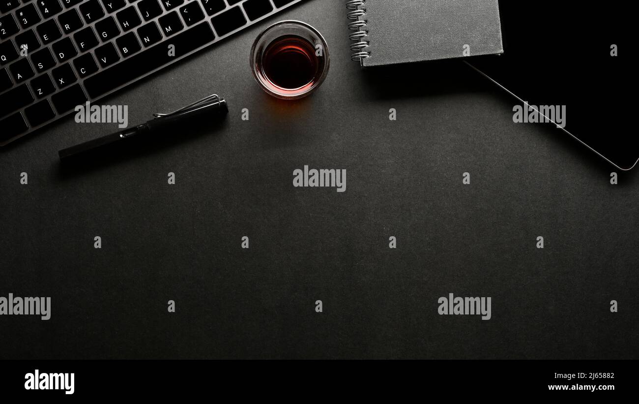 Modern black workspace background with accessories and copy space for ...