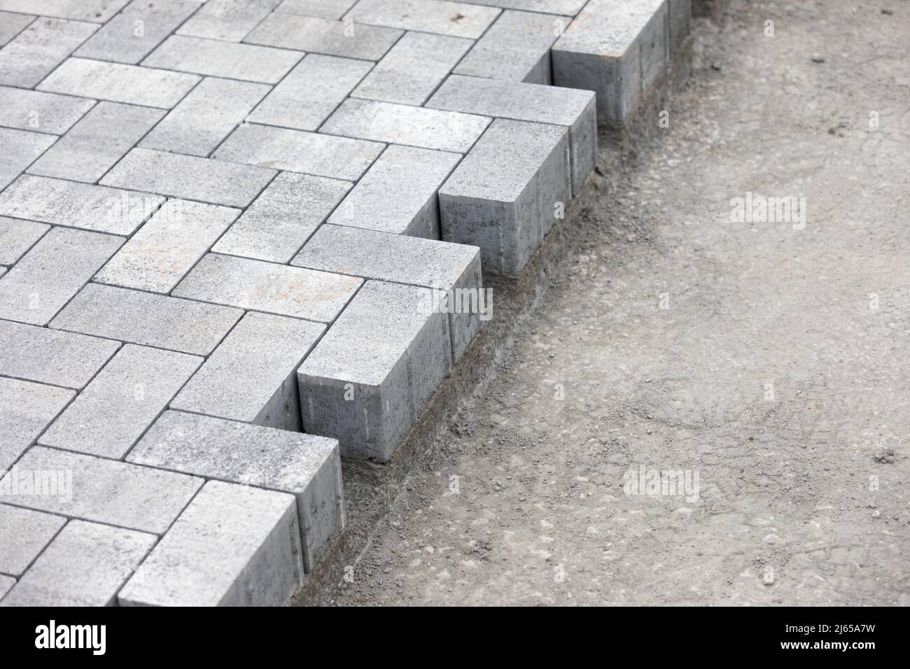 Installing and laying pavement stones on sidewalk Stock Photo - Alamy