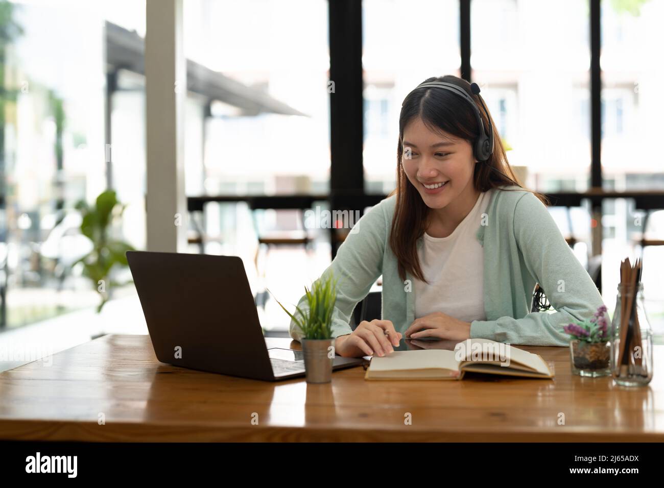 Asian woman writing making list taking notes in notepad working or ...