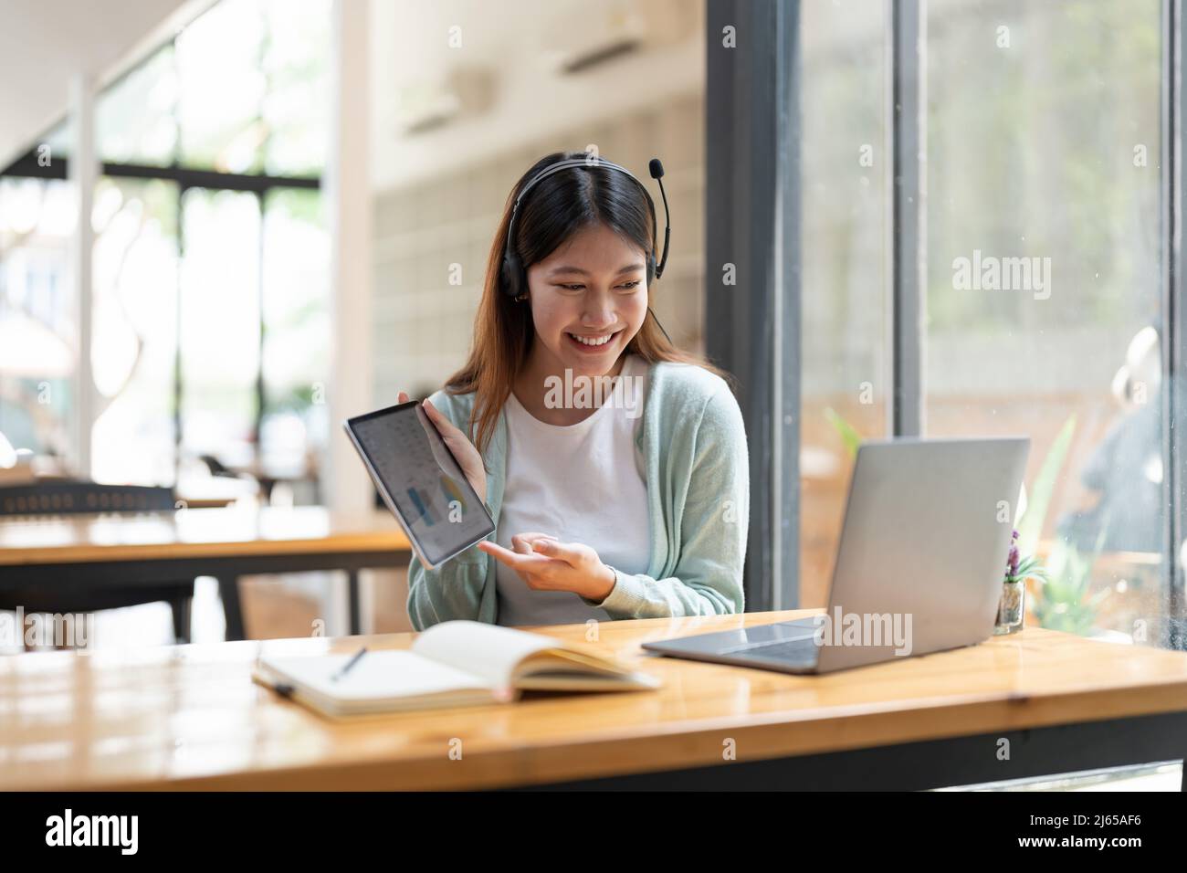 Asian woman writing making list taking notes in notepad and digital ...