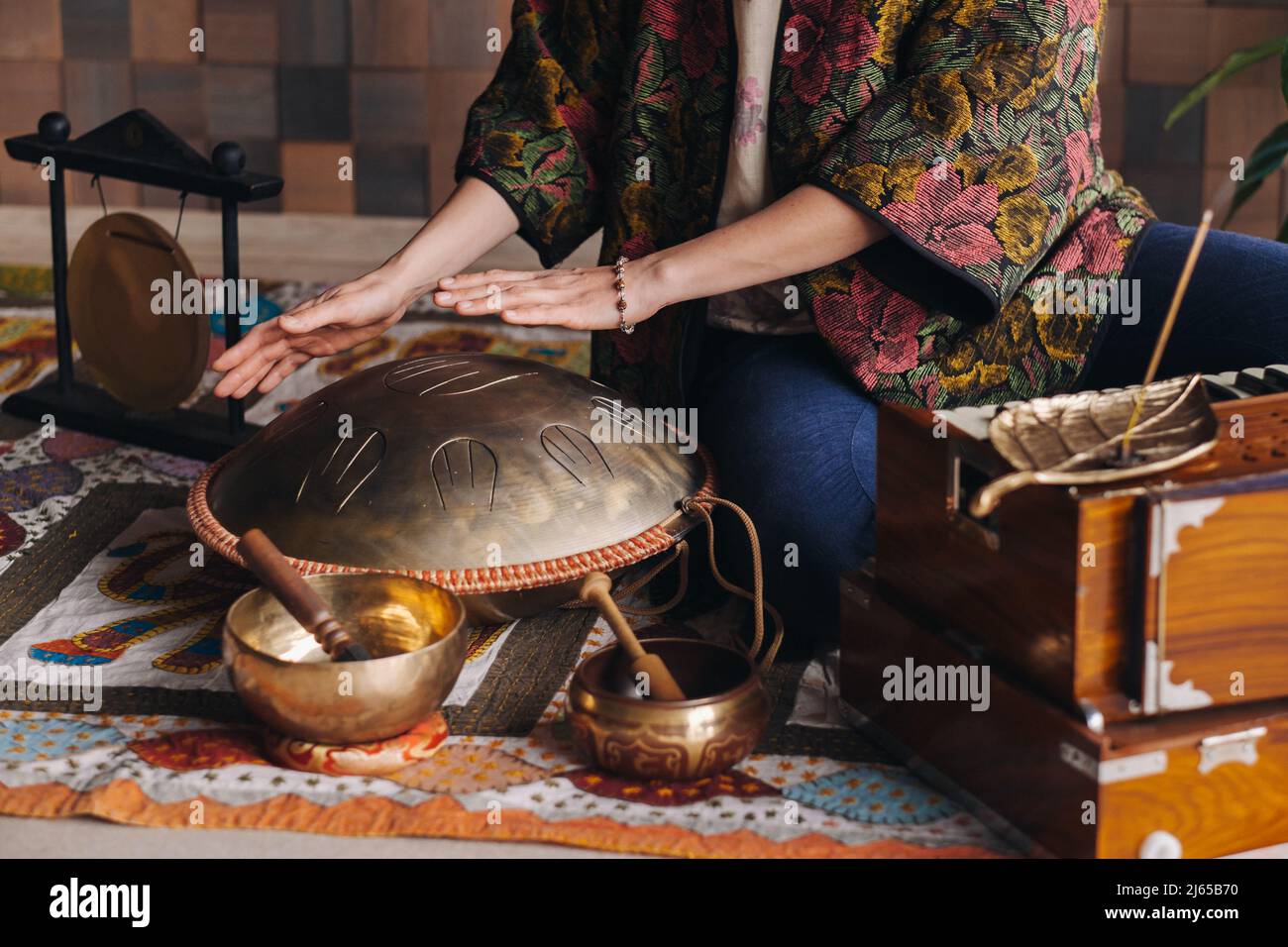 Close-up of a woman's hand playing a modern musical instrument - the ...