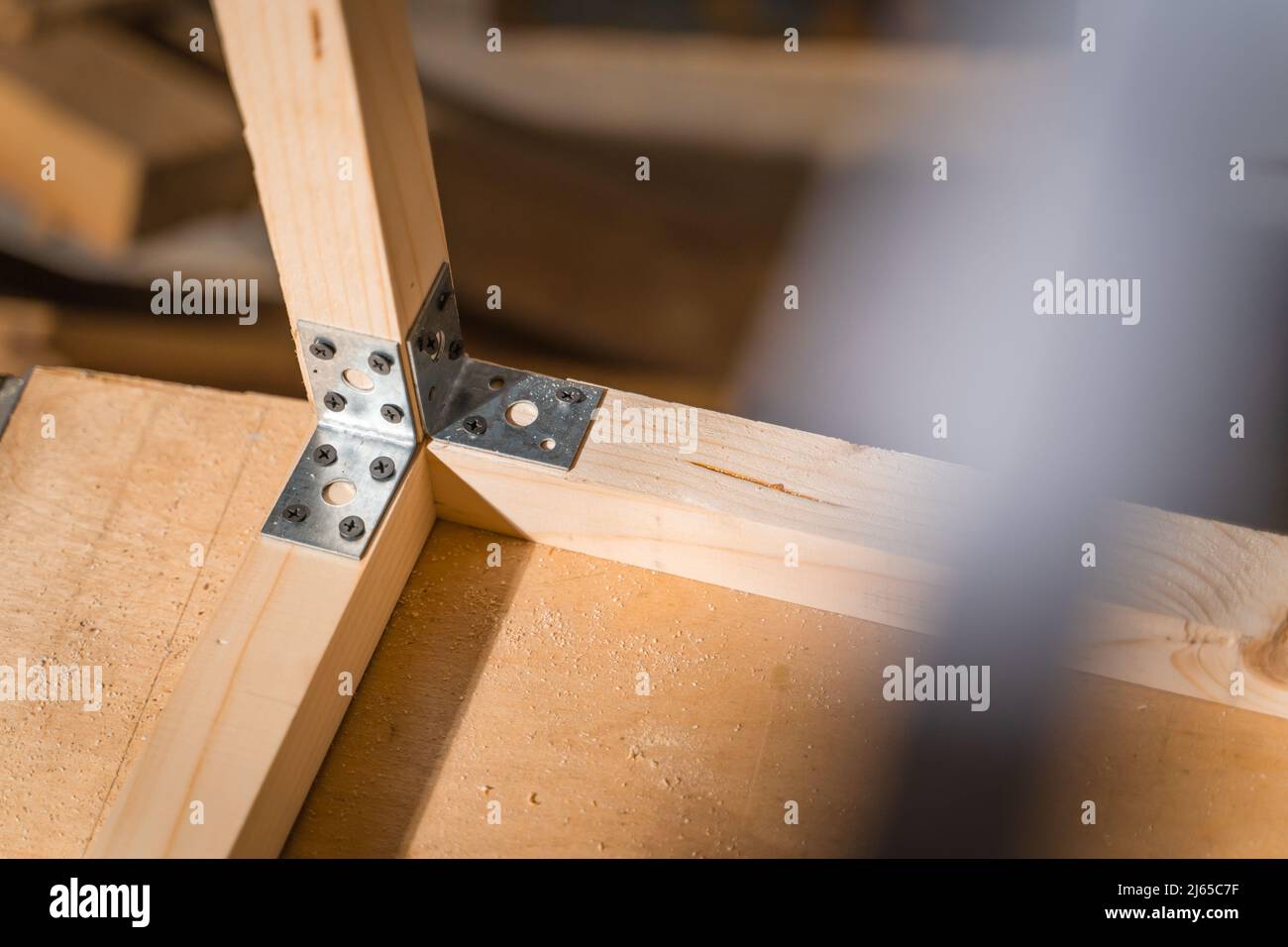 Corner connection of wooden bars with iron corners and black self ...