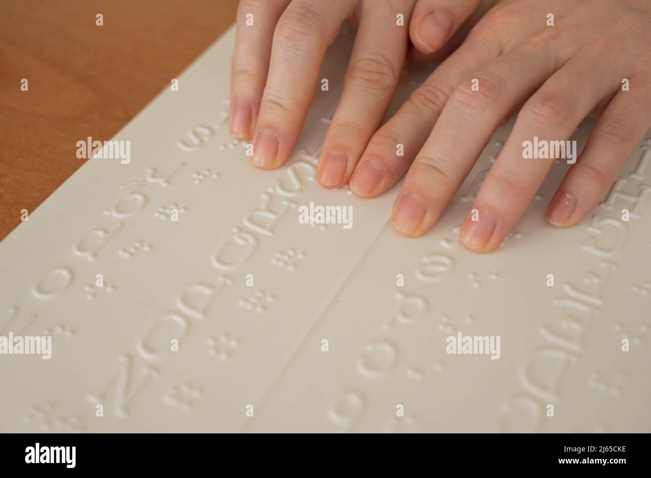A woman learns the Braille alphabet using a decoder Stock Photo - Alamy