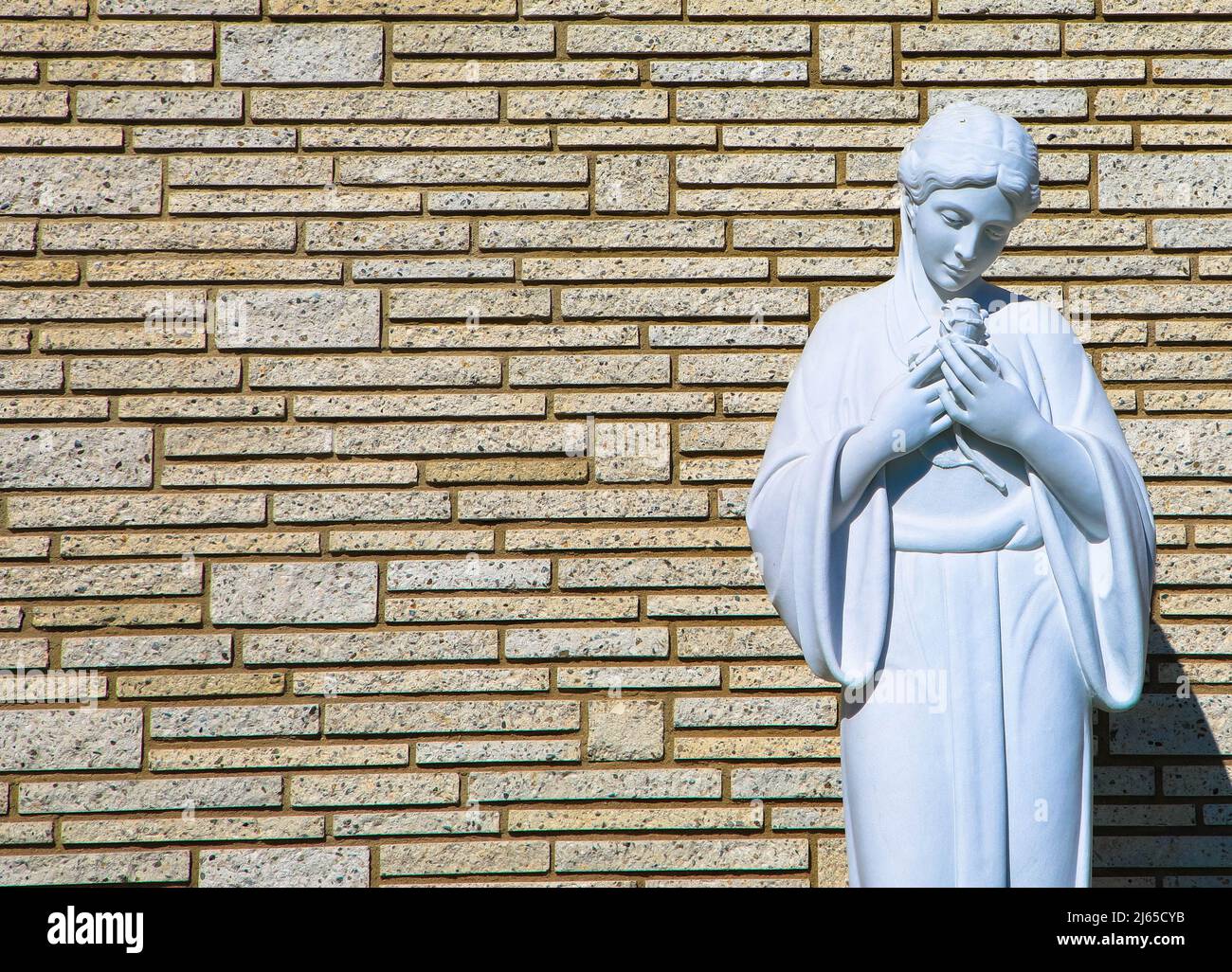 Magnificent plaster statue of a woman against brick wall. Symbol of ...