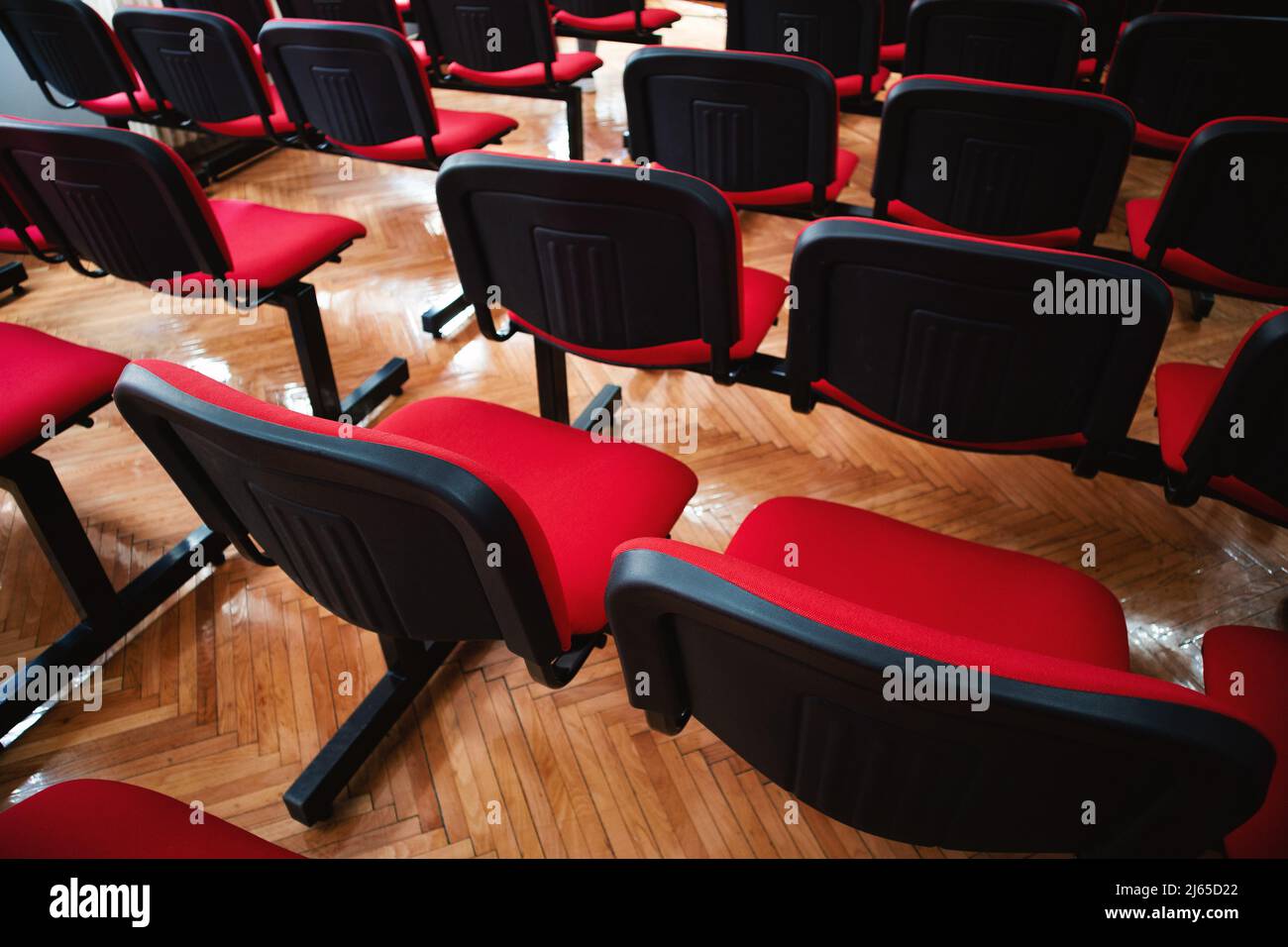 Interior of a classroom with red chairs Stock Photo - Alamy